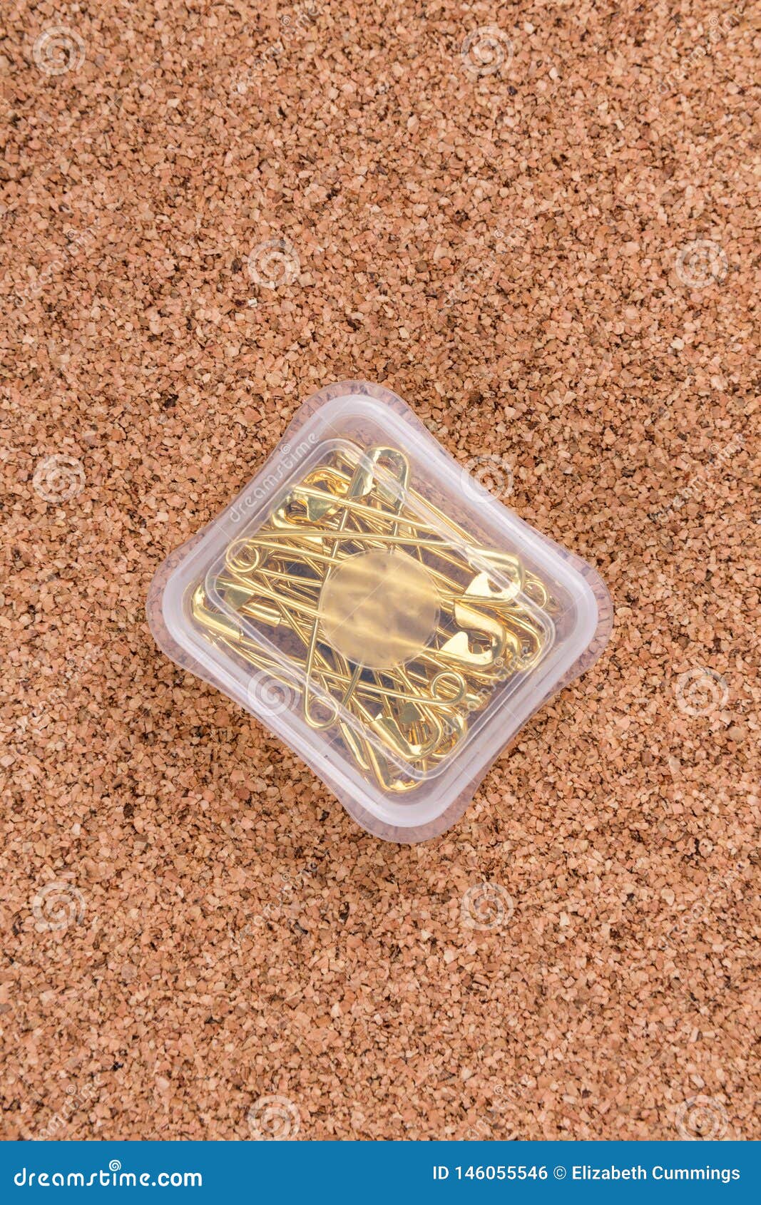 Gold Safety Pins in a Container on a Piece of Cork Stock Photo - Image ...