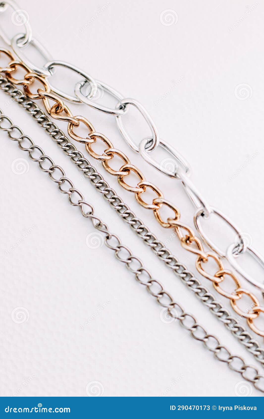 Gold and Silver Jewelry Chains of Different Diameters on a White ...