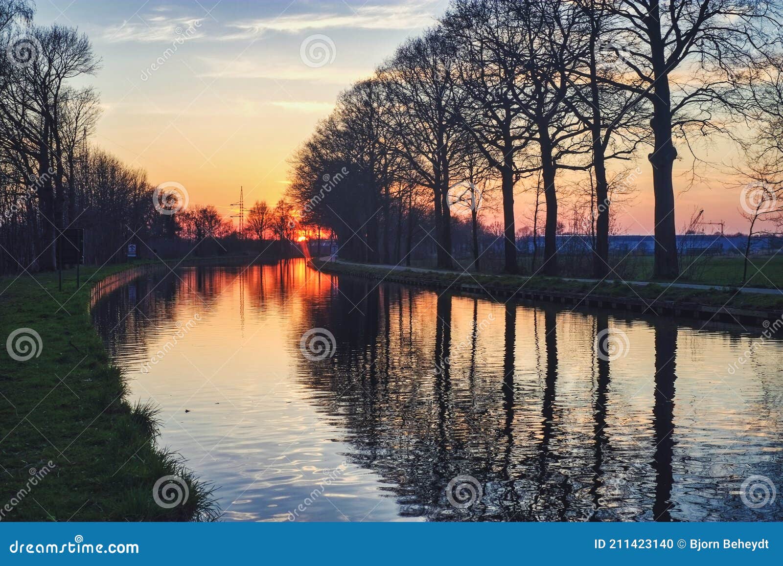 Gold Sunset Over River with Sun Rays, Tree Silhouettes and Reflection ...