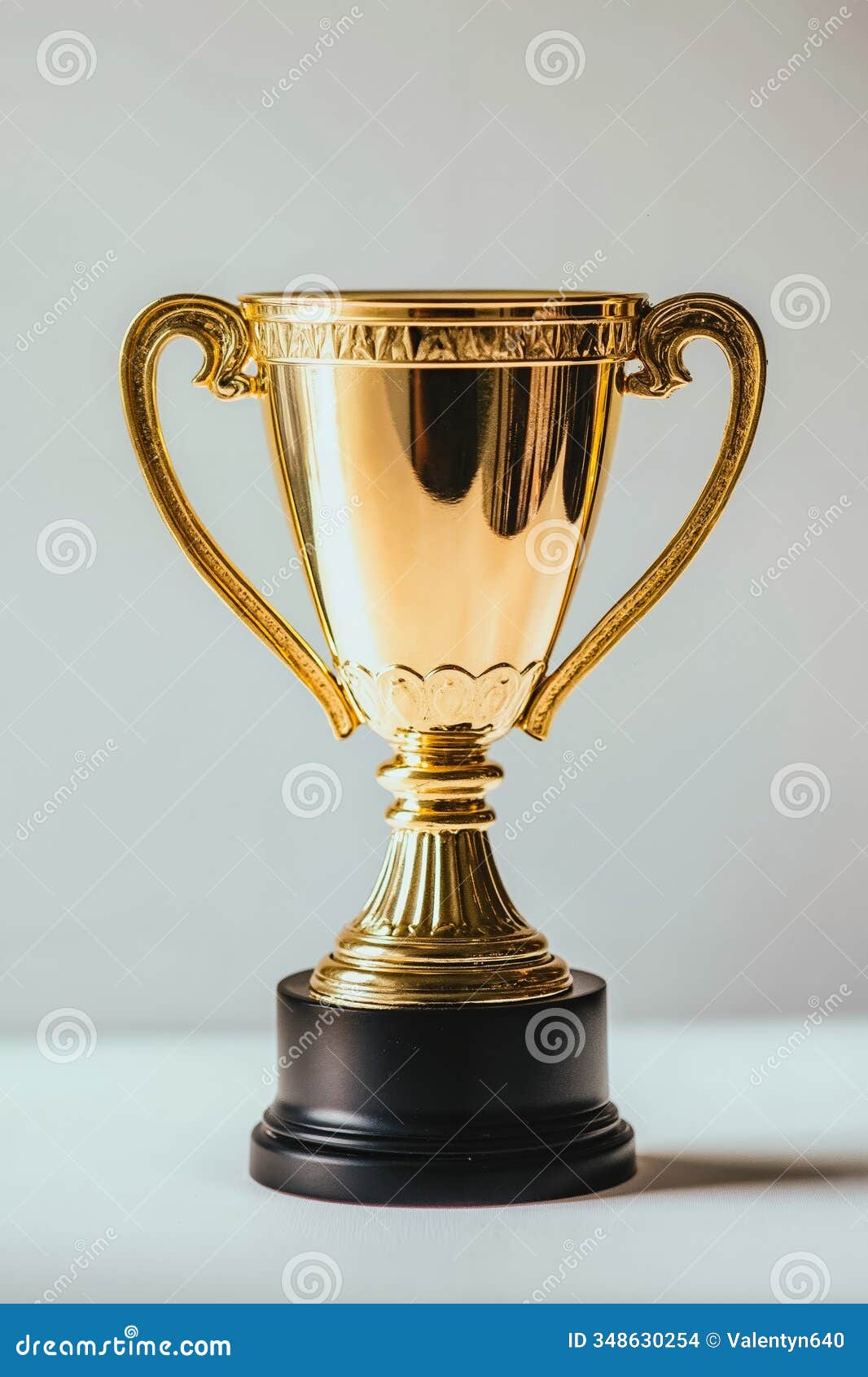 A Gold Trophy Sitting on Top of a Black Base Stock Photo - Image of ...