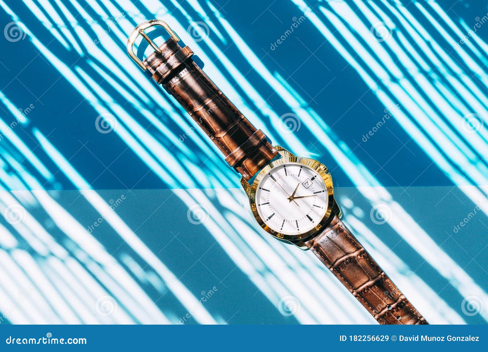 Gold Watch on a Blue Background Stock Image - Image of quartz, premium ...