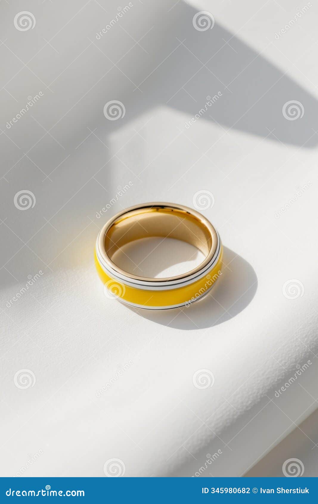 A Gold and White Ring with a Yellow Band. Stock Photo - Image of ring ...