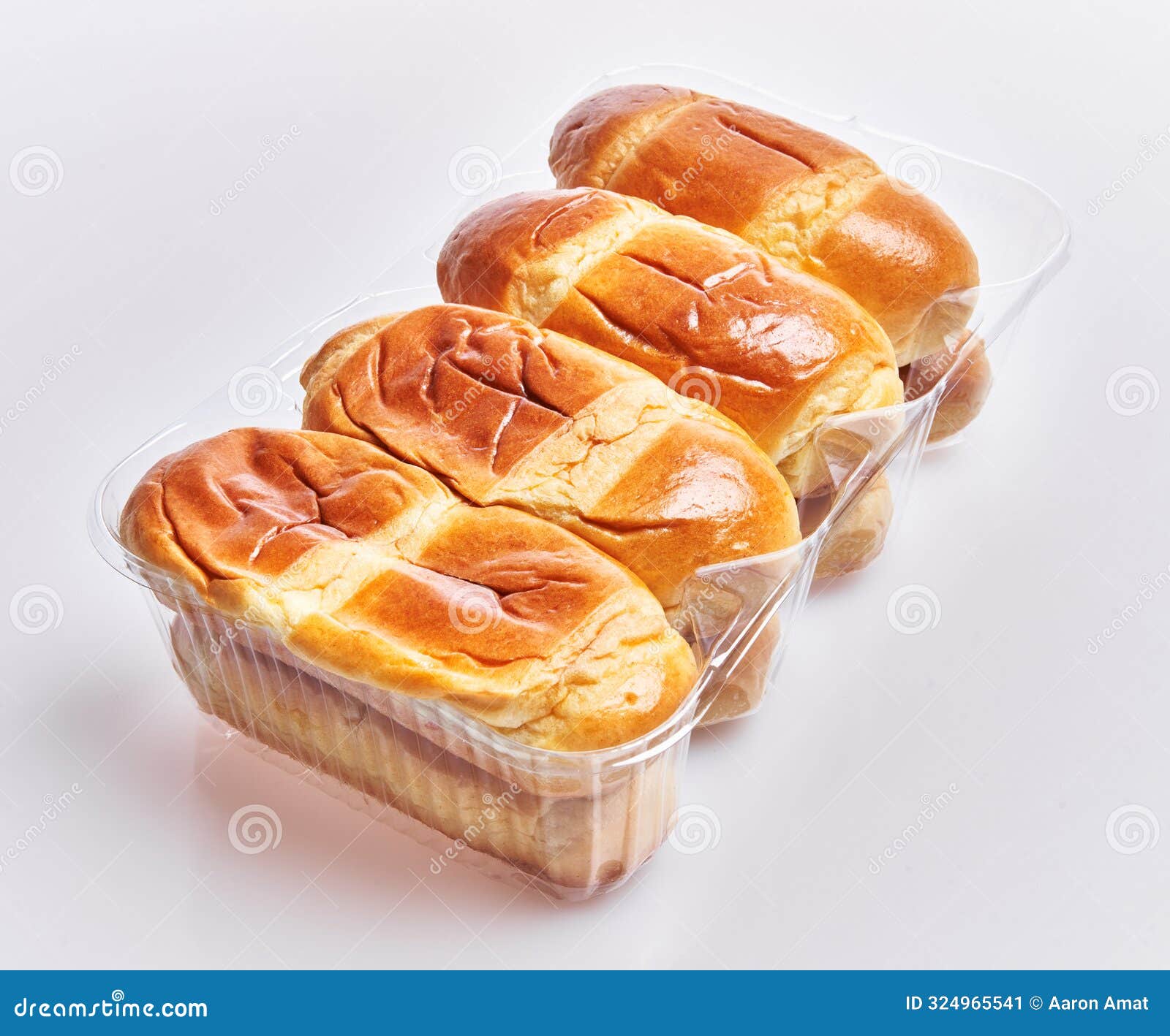 Golden Baked Bread in Clear Plastic Packaging Isolated on a White ...
