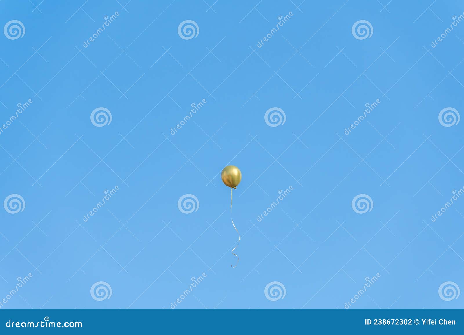 A Golden Balloon Flew Under the Blue Sky and White Clouds Stock Photo ...