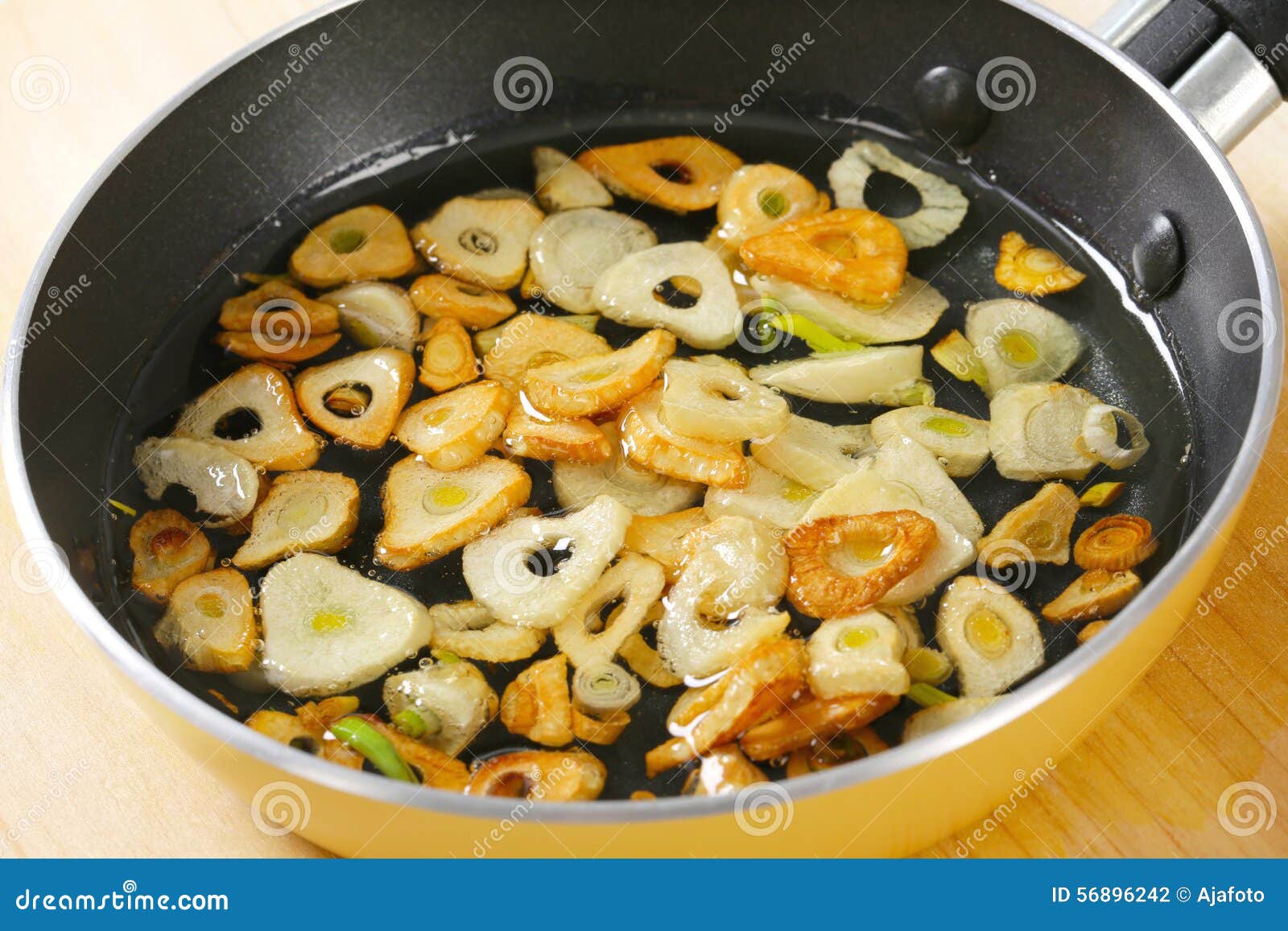 Golden brown sliced garlic stock photo. Image of utensil - 56896242