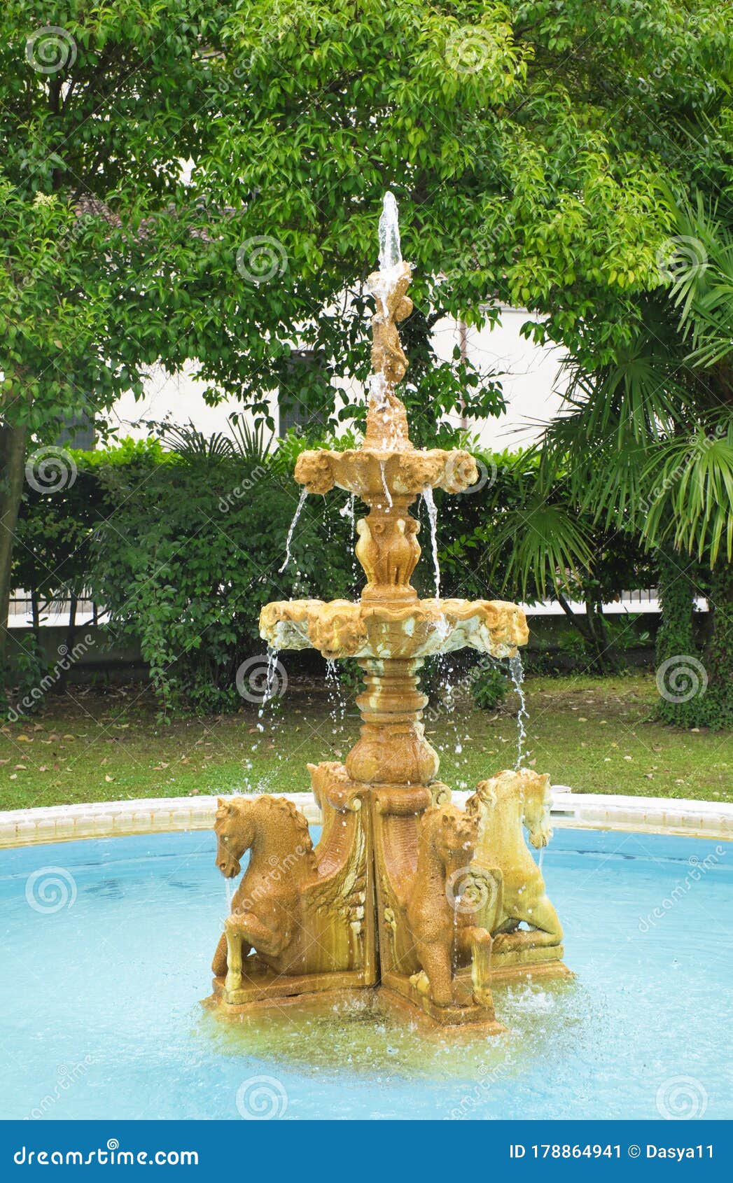 Golden Colored Monumental Fountain with Blue Water Fall Down Stock ...