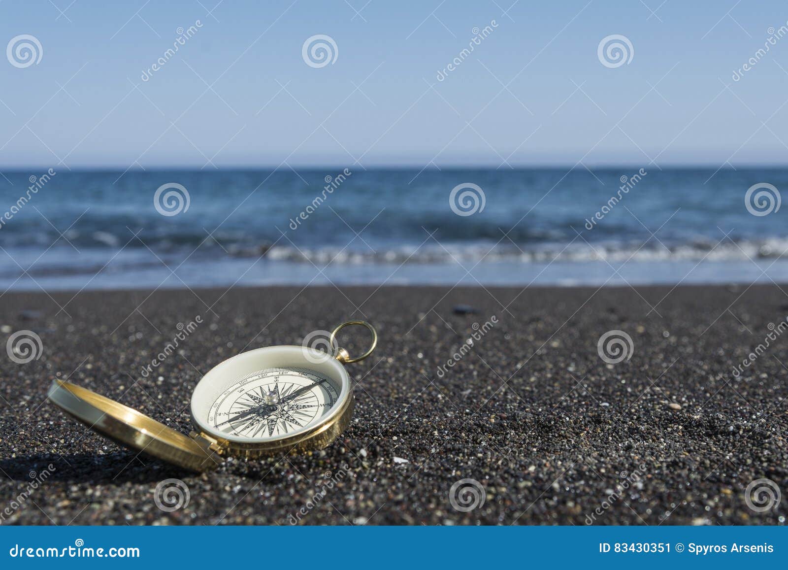 Golden Compass on the Seashore. Focus on Compass Stock Image - Image of ...