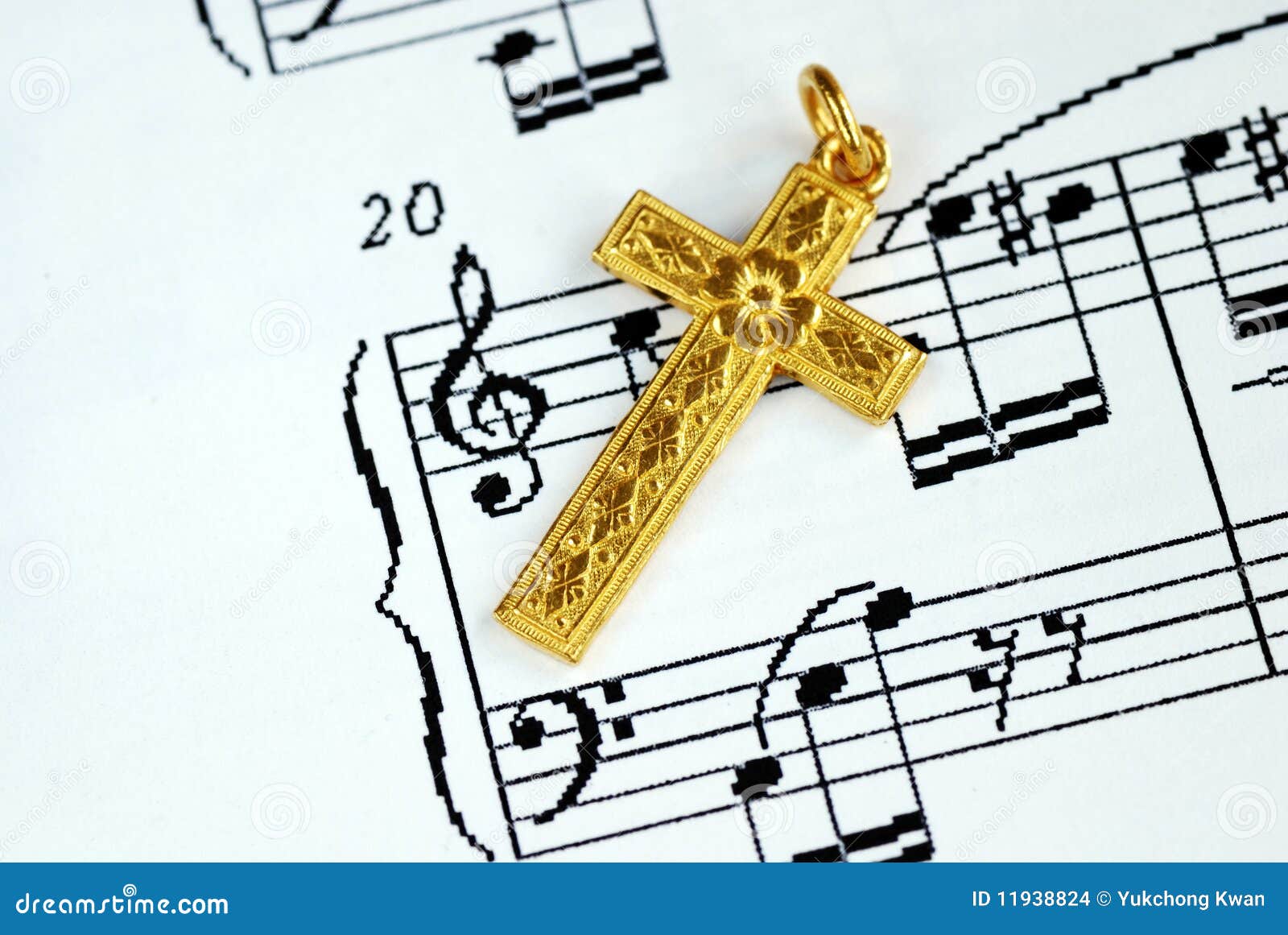 A Golden Cross on the Top of a Music Sheet Stock Photo - Image of audio ...