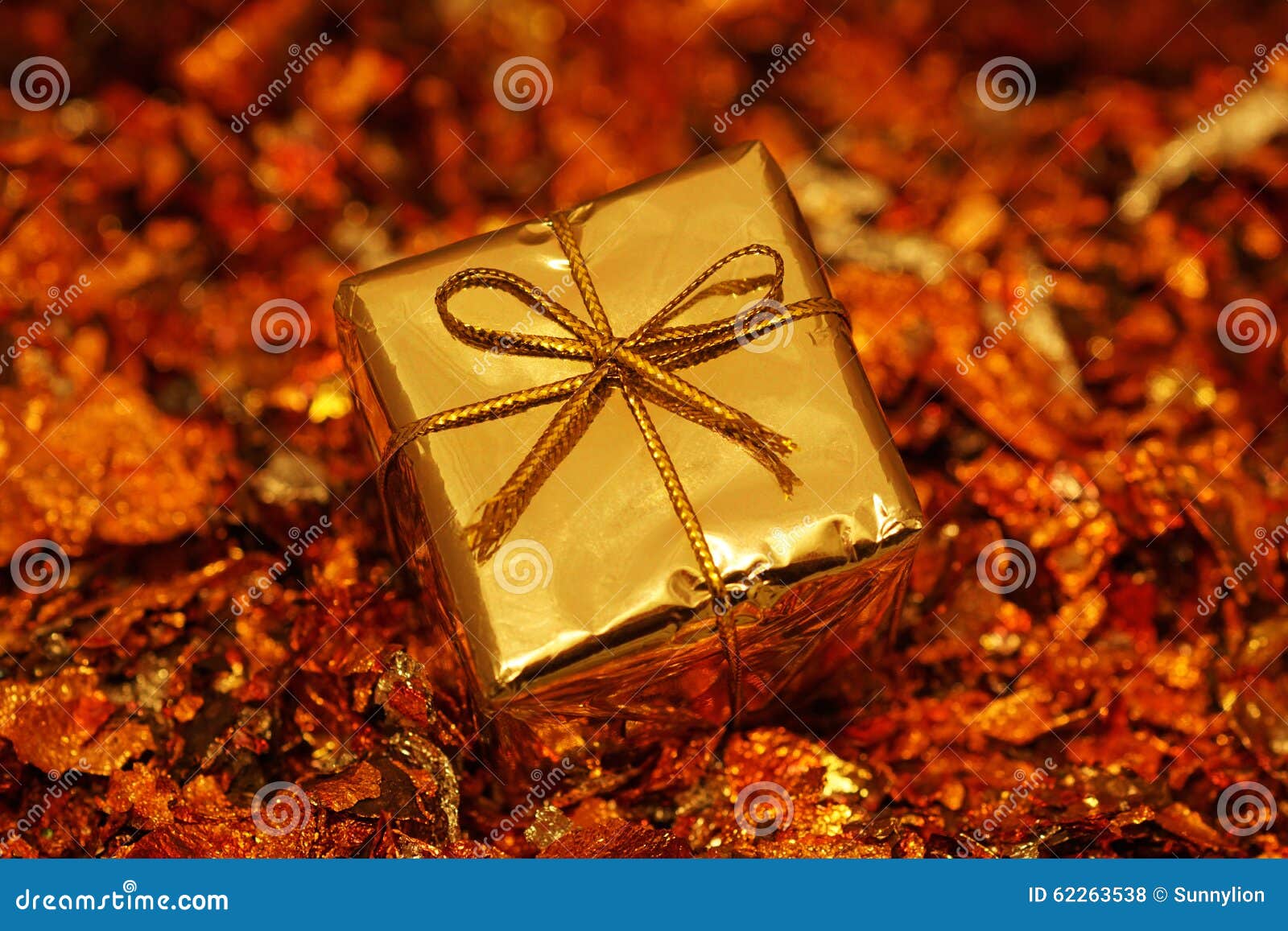 Golden Decorative Box with Holiday Gift on Red Background Stock Photo ...