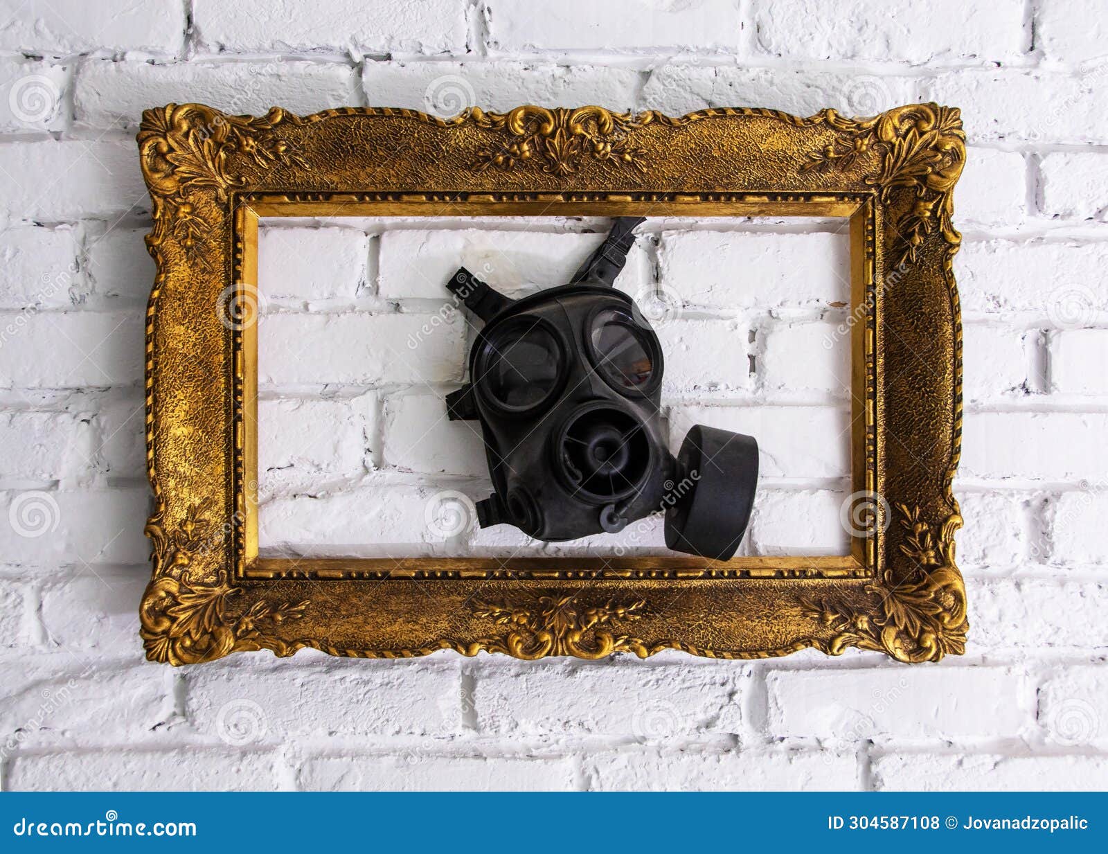 Golden Frame with Black Gas Mask on White Brick Wall Stock Photo ...