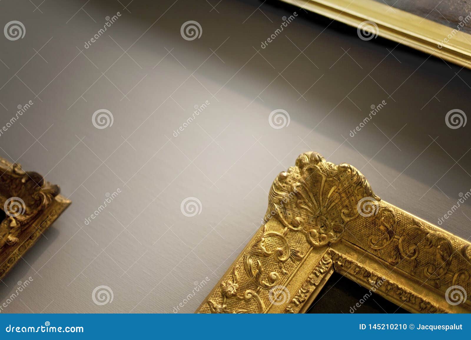 Golden frames in a gallery stock photo. Image of painting - 145210210