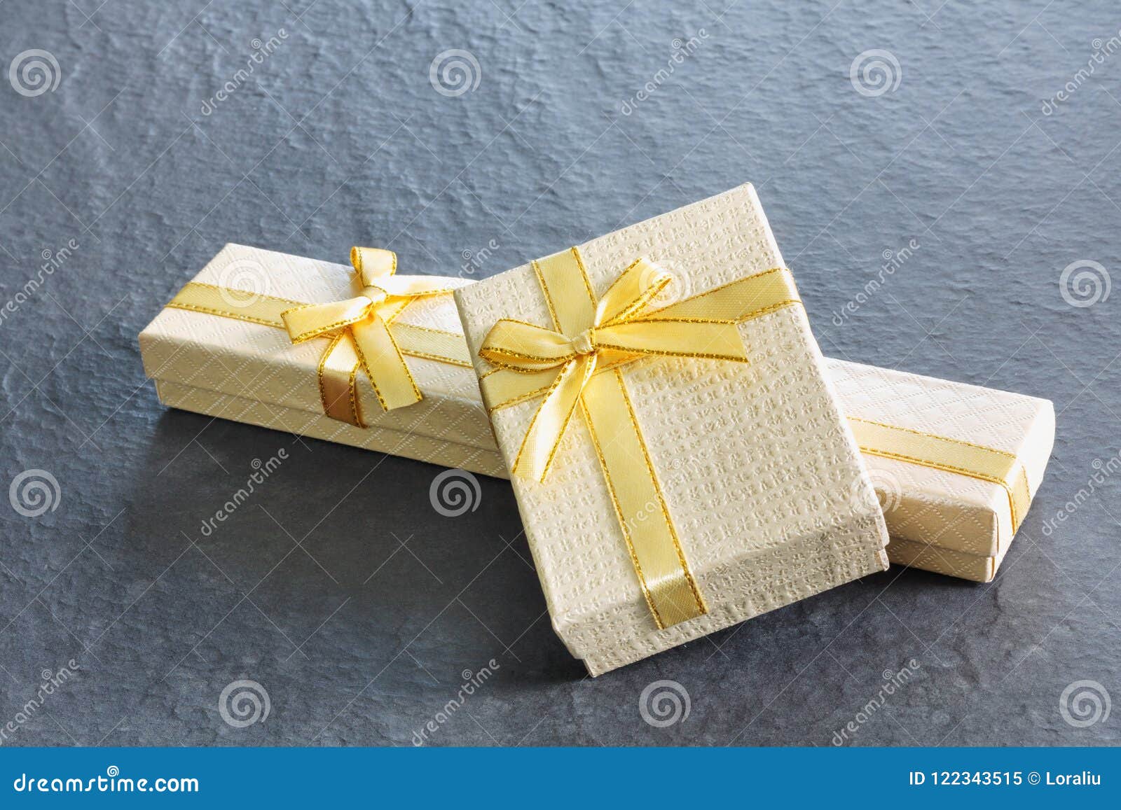 Golden Gift Boxes with a Bow on Stone Table Stock Image - Image of ...