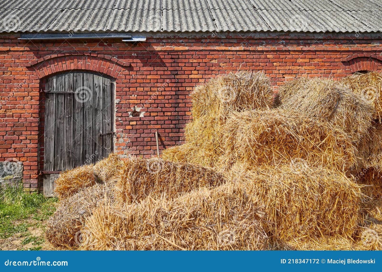 Golden Haystack in Front of an Old Brick Building Stock Photo - Image ...