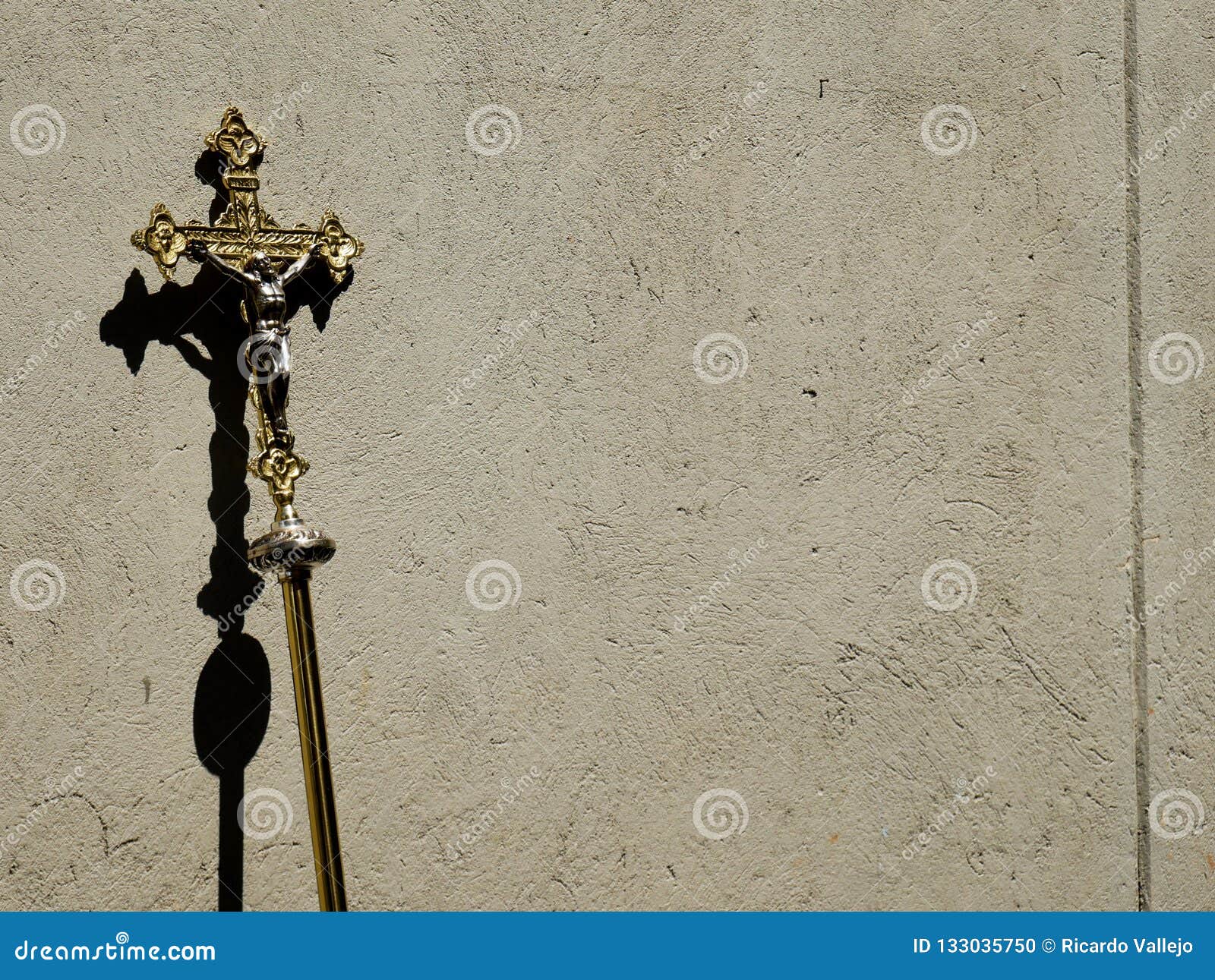 Golden Holy Processional Cross Leaning on a Concrete Wall with Shadow ...