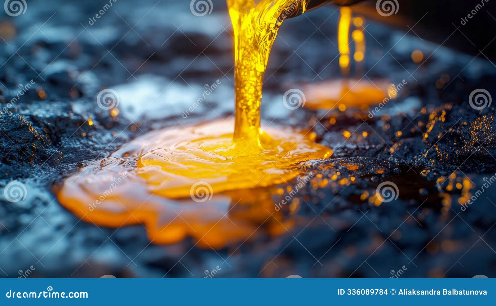 A Golden, Molten Liquid Flows Onto a Dark Surface, Creating a Vivid ...