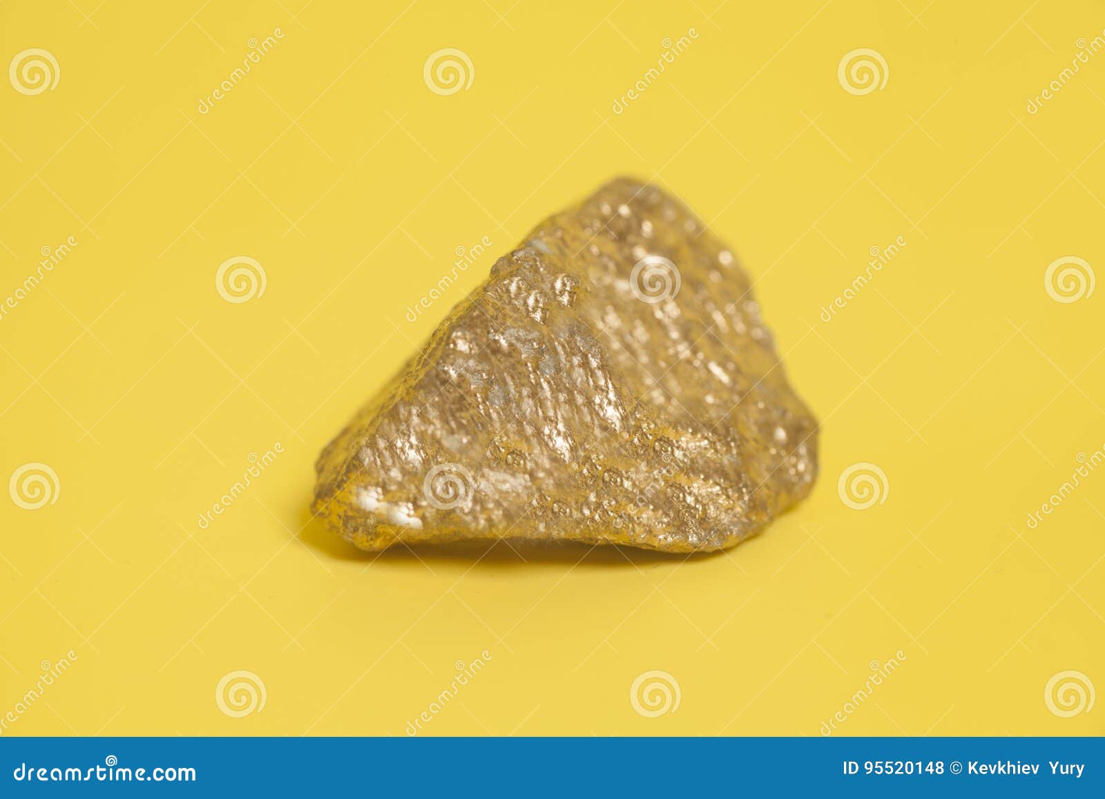 Golden nugget on a yellow stock photo. Image of heap - 95520148