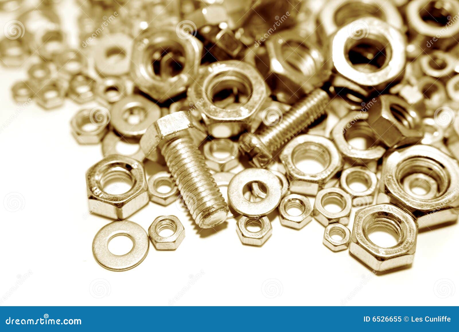 Golden Nuts & Bolts stock image. Image of industrial - 6526655
