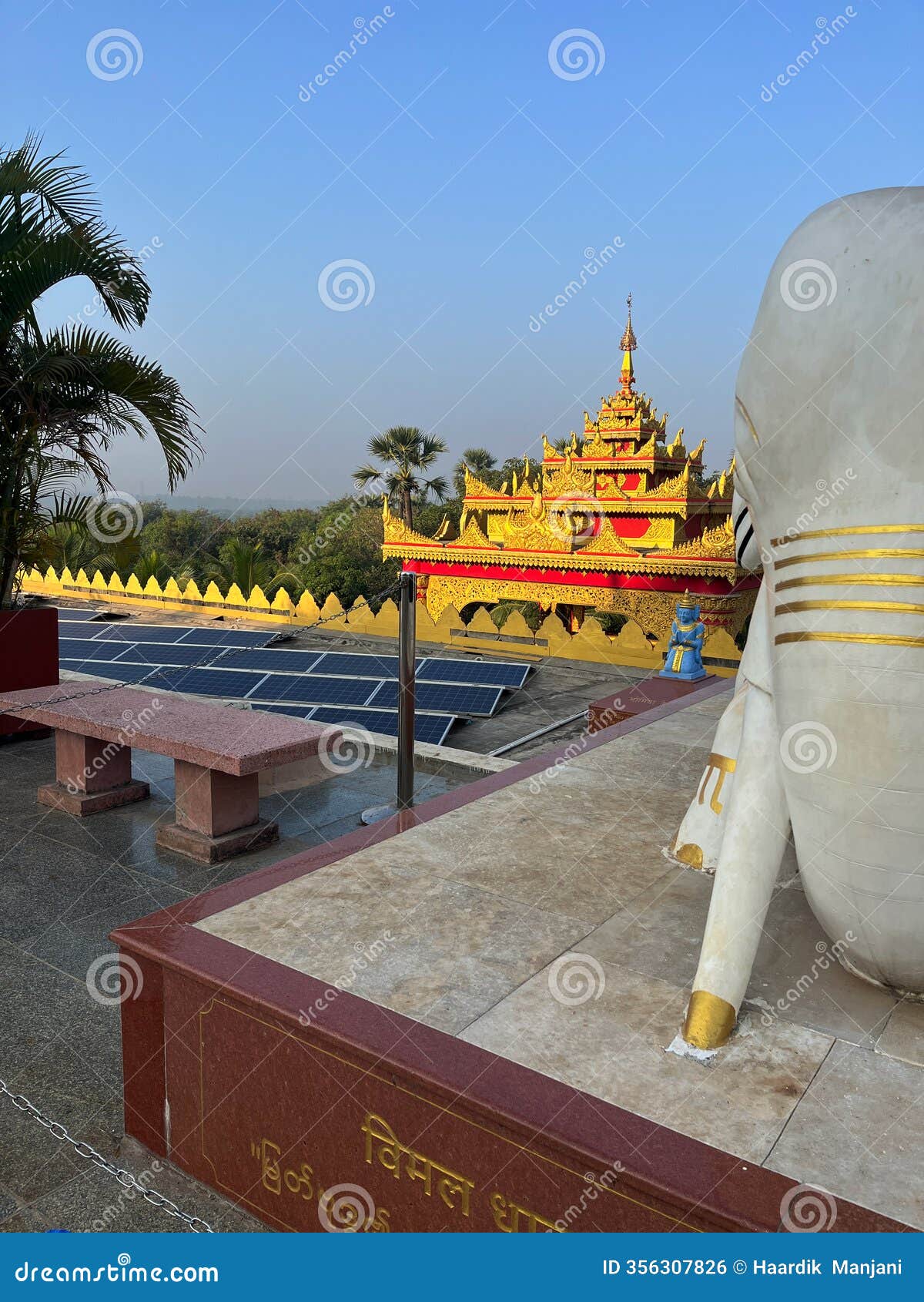 Golden Pagoda and Elephant Statue with Solar Panels in Temple Complex ...