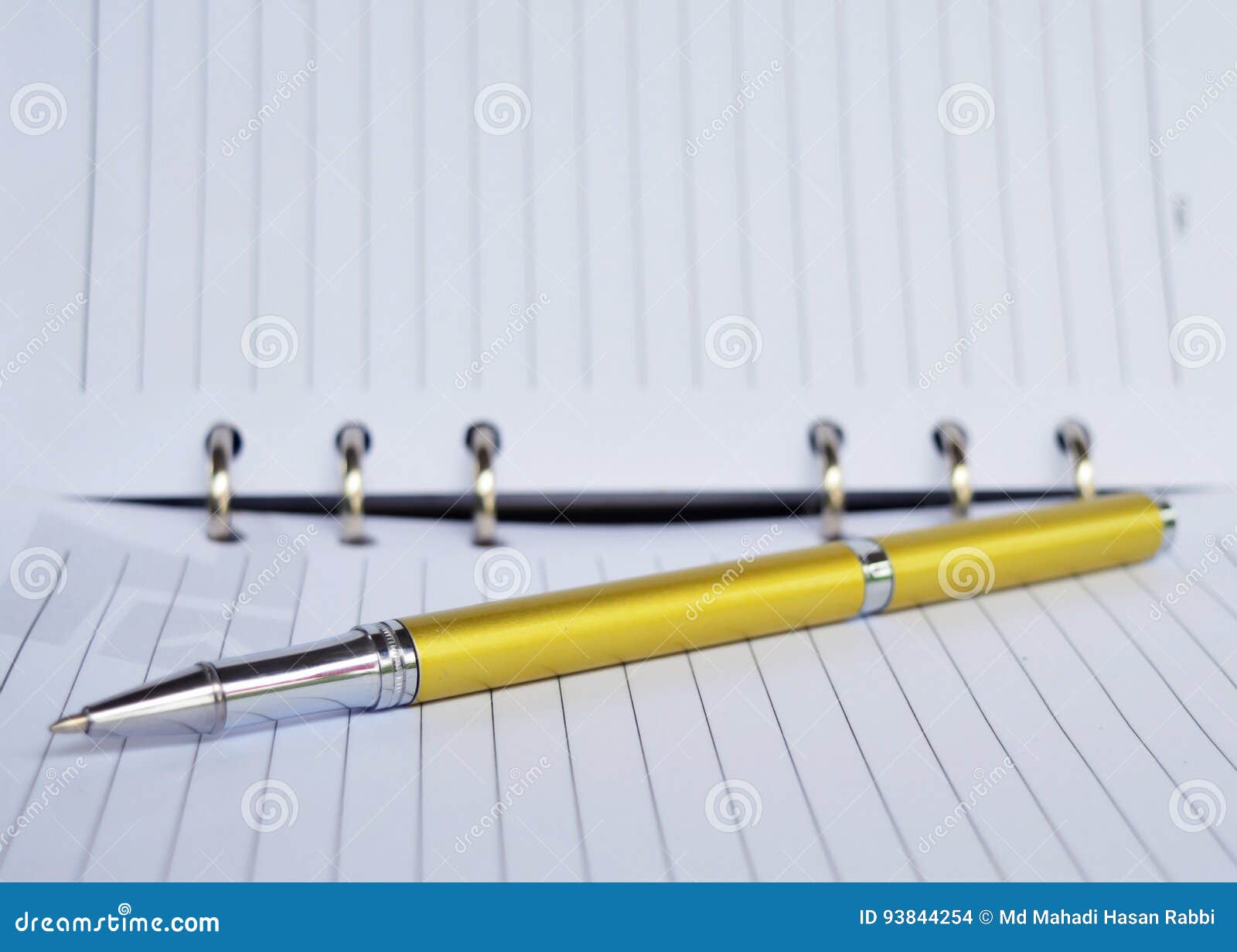 Golden Pen on note pad stock photo. Image of arrange - 93844254