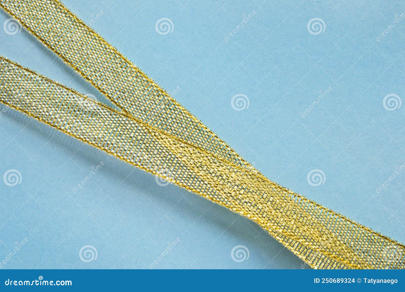 Golden ribbon on blue stock photo. Image of wrapping - 250689324