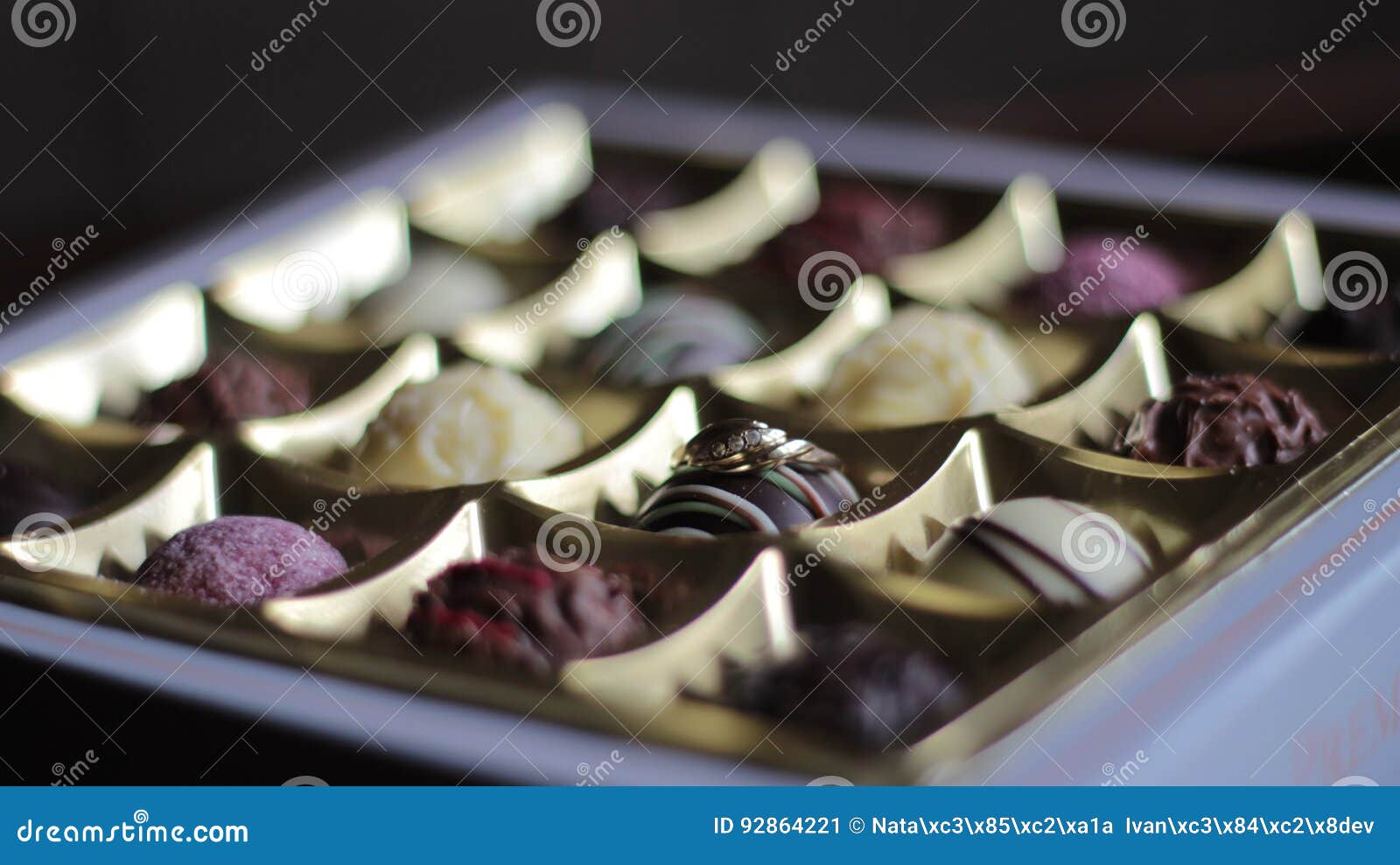 A Golden Ring in a Luxury Box of Chocolates Stock Image - Image of ball ...
