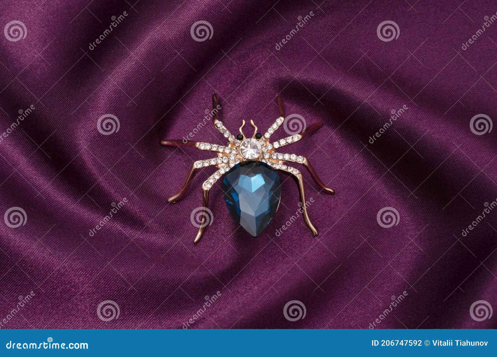 Golden Spider with a Big Blue Stone on Silk Fabric Stock Photo - Image ...