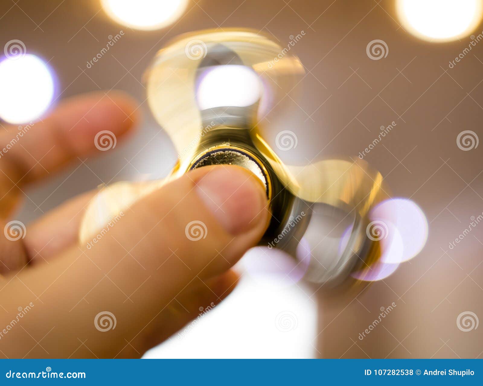 The Golden Spinner is Spinning in His Hand Stock Photo - Image of ...