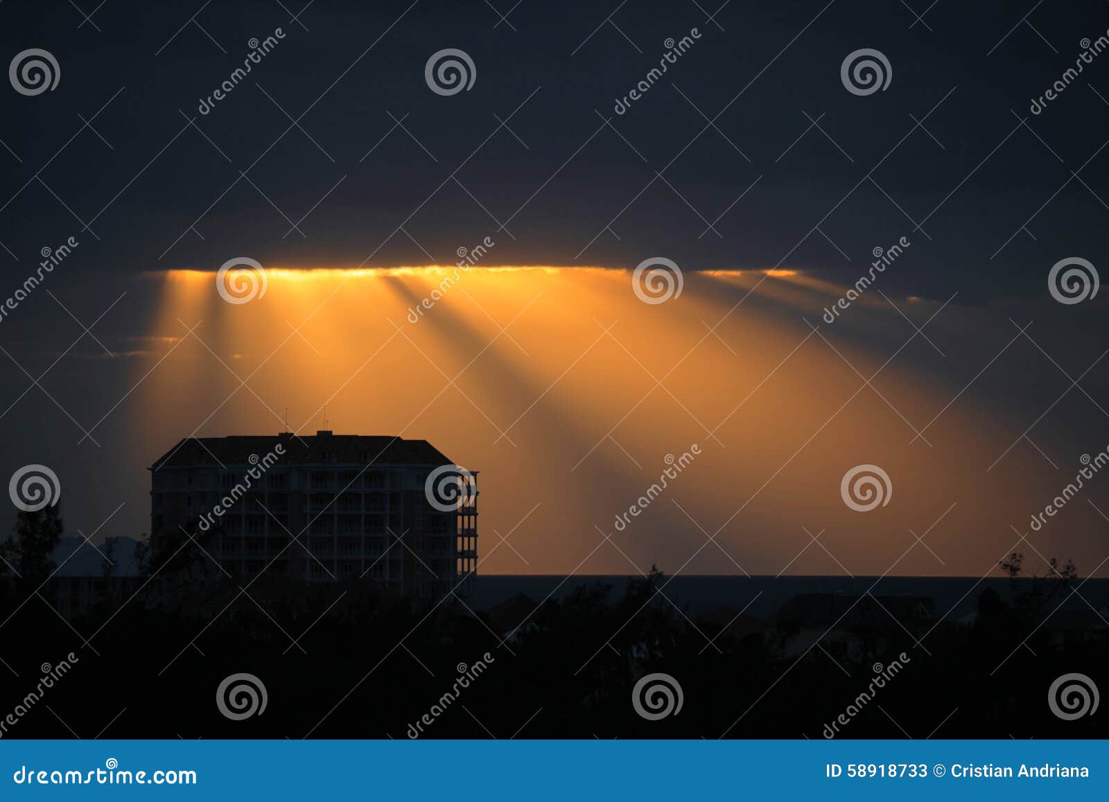 Golden Sun Rays Bursting through the Dark Blue Clouds Stock Image ...