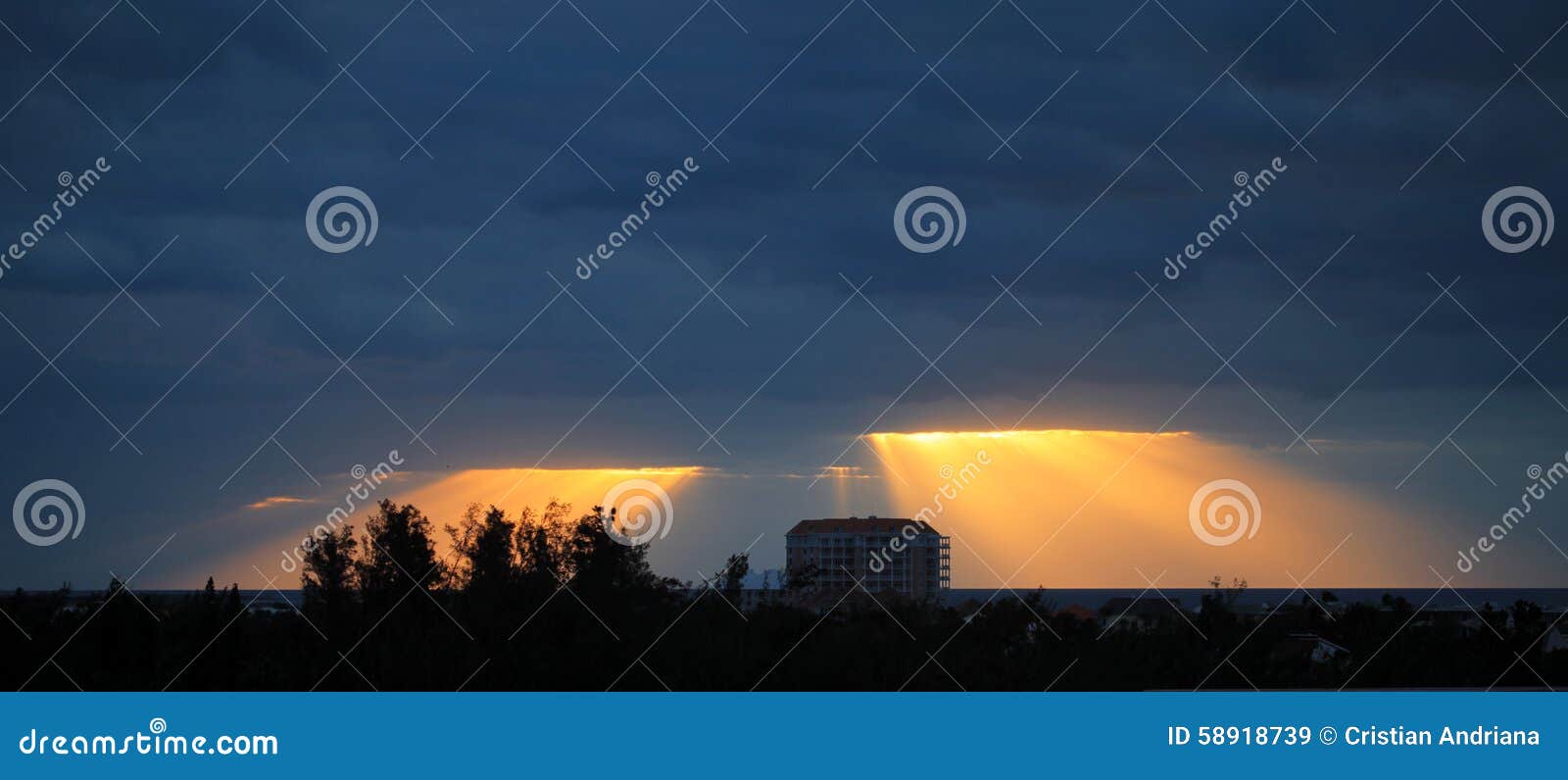 Golden Sun Rays Bursting through the Dark Blue Clouds Stock Image ...