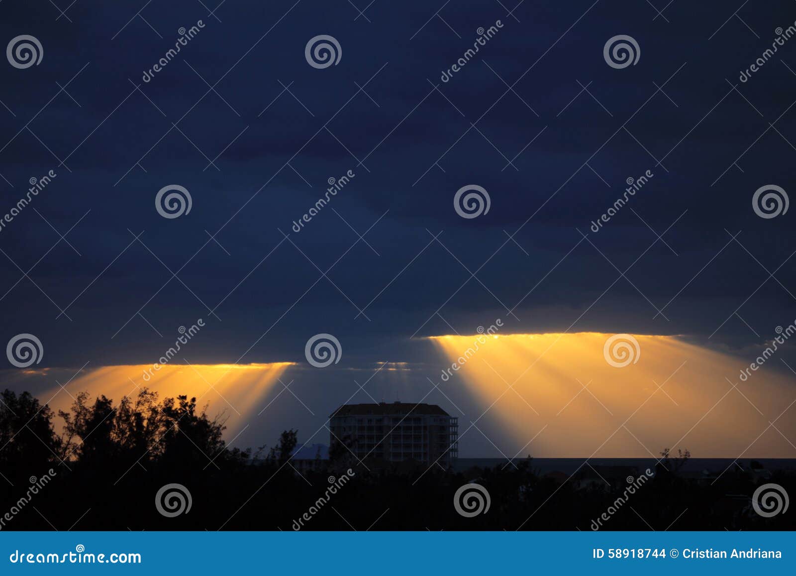Golden Sun Rays Bursting through the Dark Blue Clouds Stock Photo ...