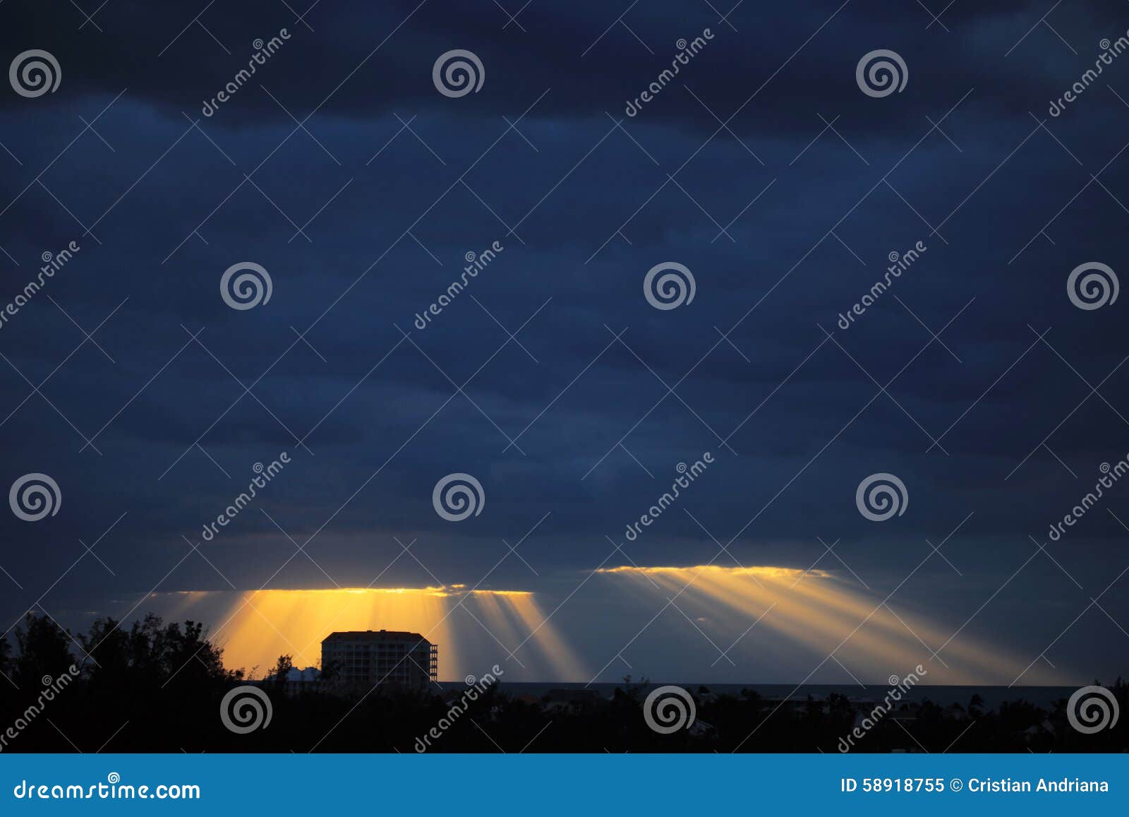 Golden Sun Rays Bursting through the Dark Blue Clouds Stock Image ...
