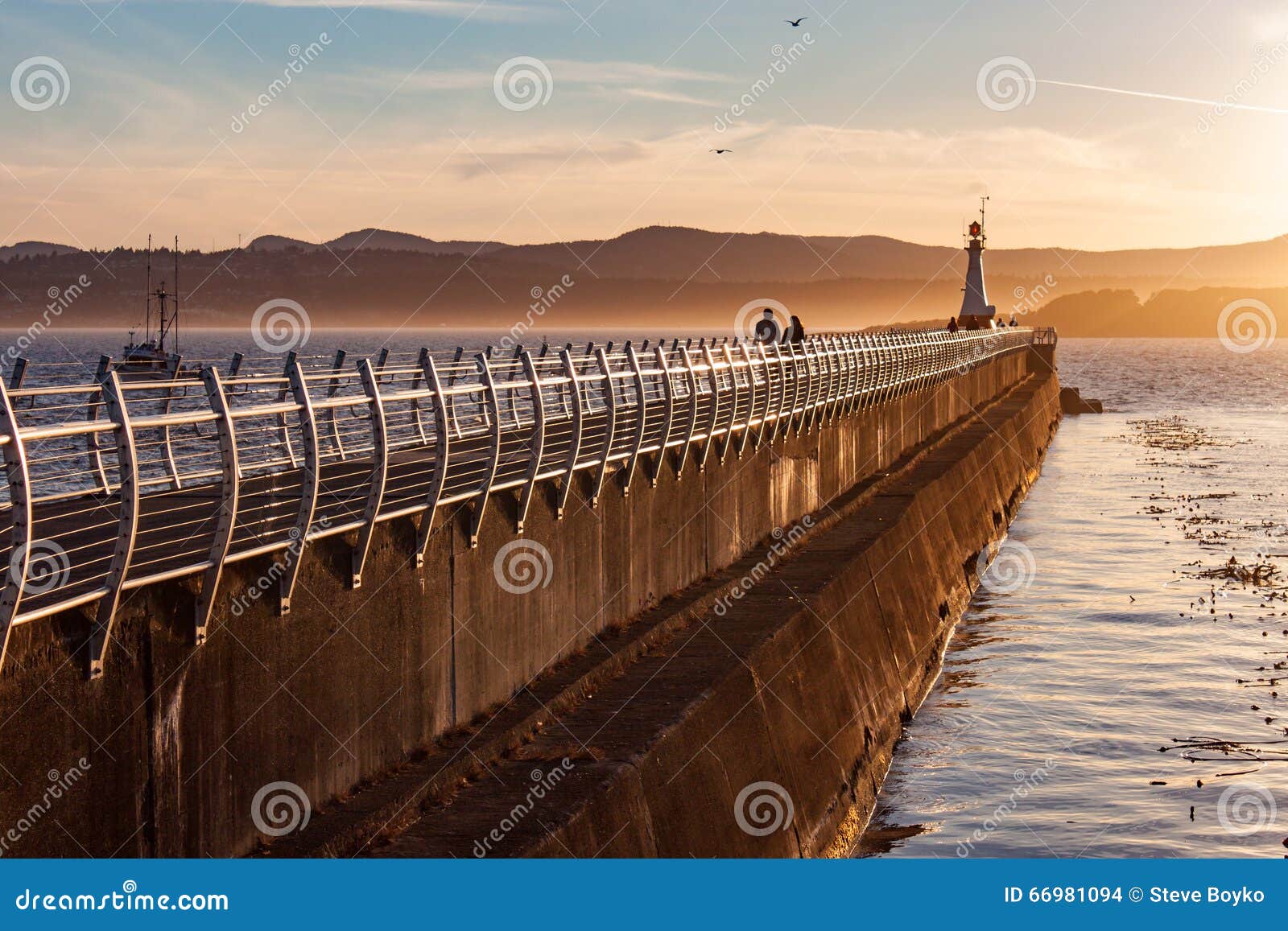 Golden Sunset Along Ocean Walkway Stock Photo - Image of reflection ...