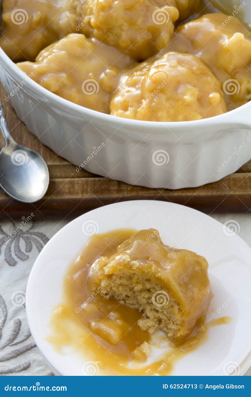 Golden Syrup Dumplings on Table with One Portion on Plate Vertical ...