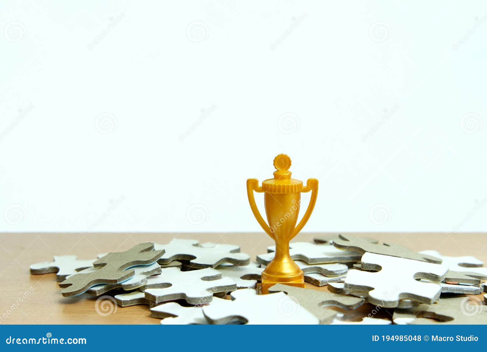 A Golden Trophy Stands between a Pile of Puzzles Stock Photo - Image of ...