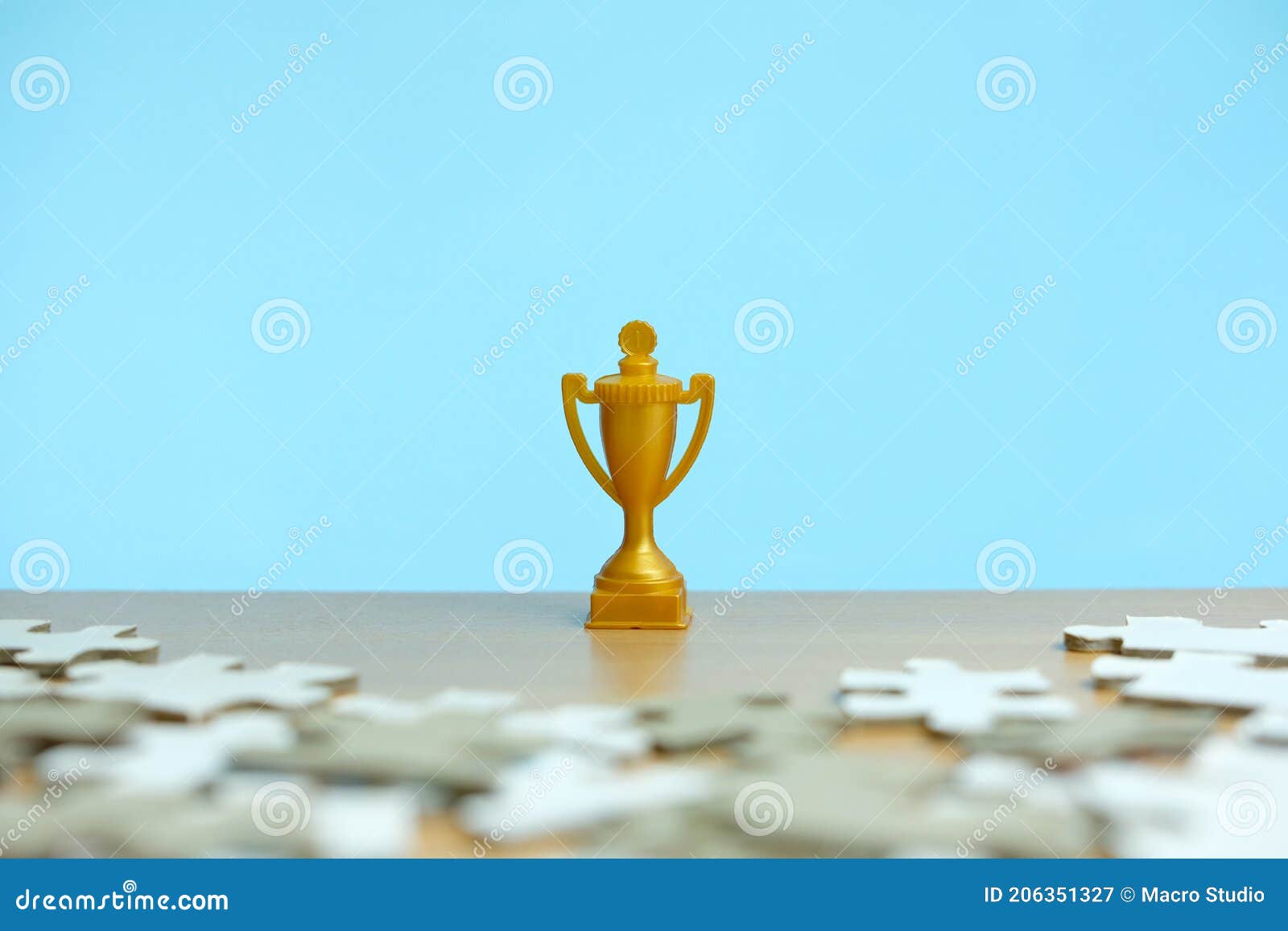 A Golden Trophy Stands between a Pile of Puzzles Stock Image - Image of ...