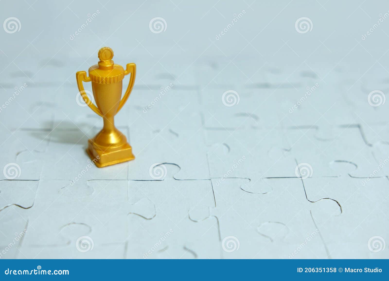 A Golden Trophy Stands between a Pile of Puzzles Stock Photo - Image of ...