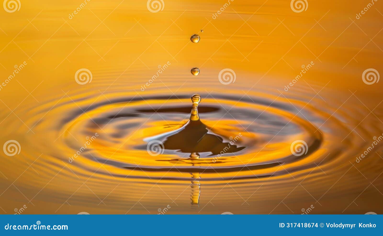 Golden Water Droplet Creating Ripples on Water Surface Stock Photo ...