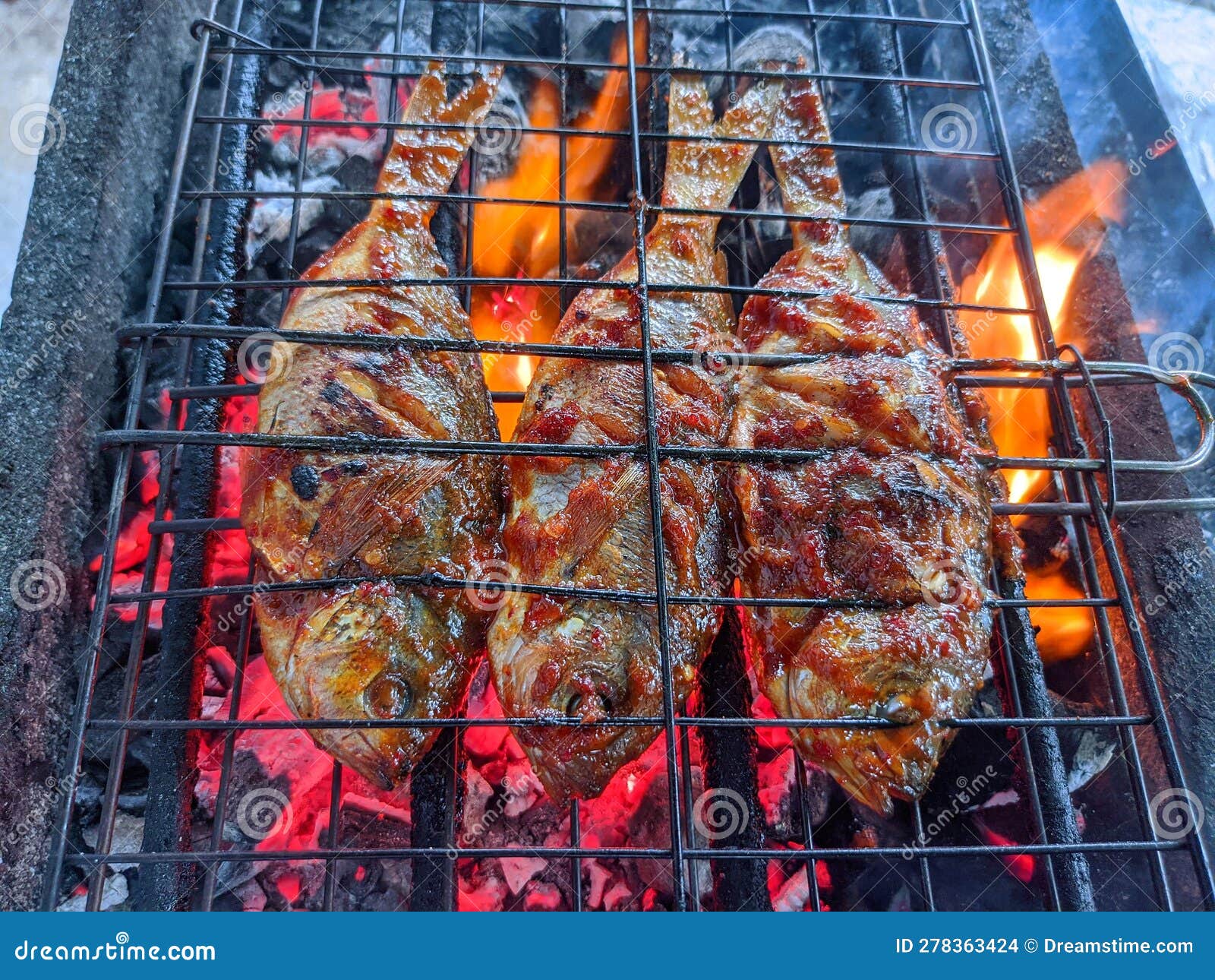 Goldfish Cooked by Burning it Makes it Addictive Stock Photo - Image of ...