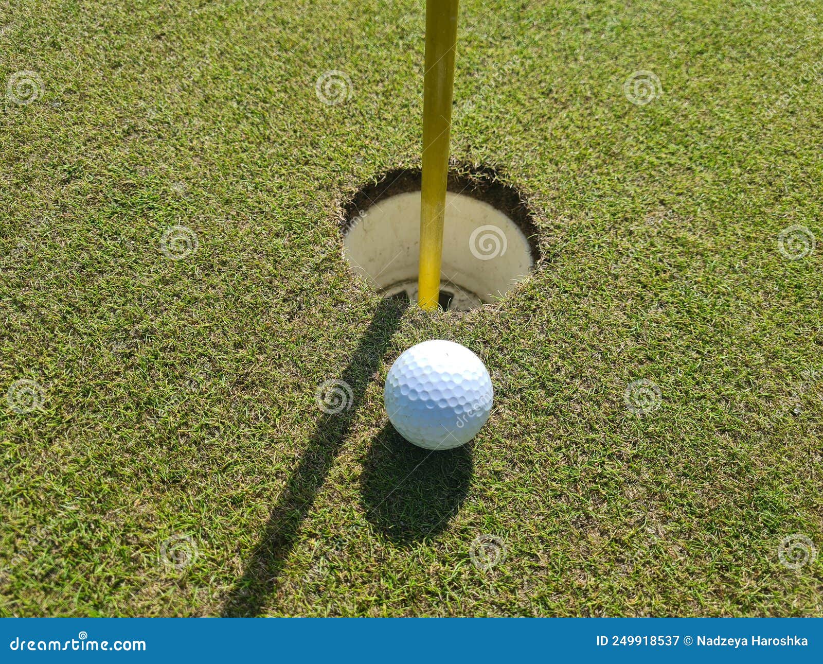 Golf Ball on the Edge of Hole on Green Closeup Stock Image - Image of ...