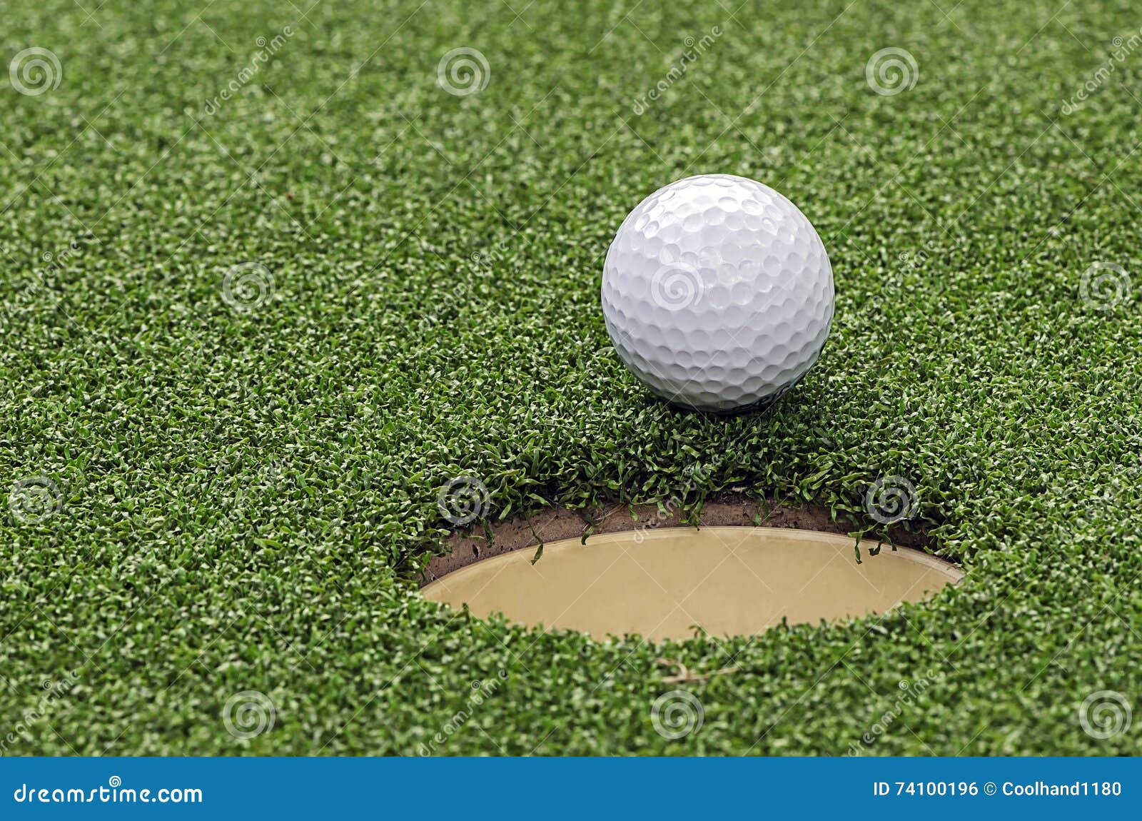 Golf ball on lip of cup stock photo. Image of golfing - 74100196