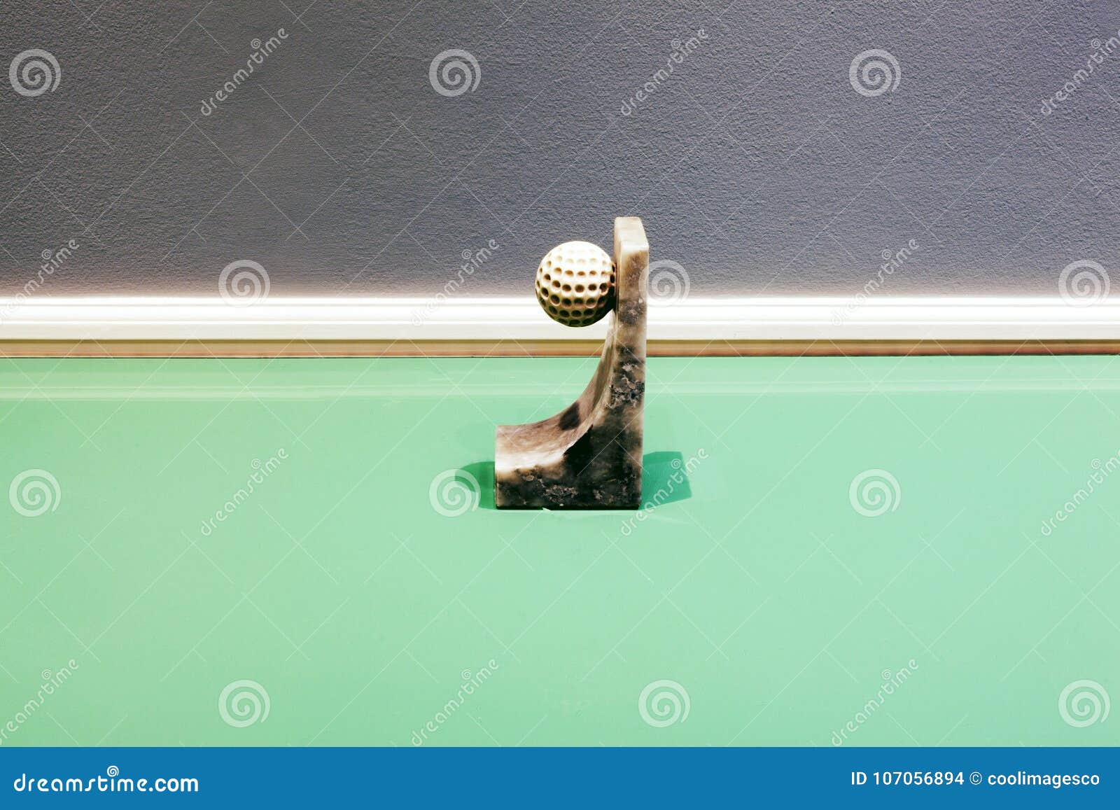 A Golf Ball with a Marble Base on Top a Glass Green Table As an ...