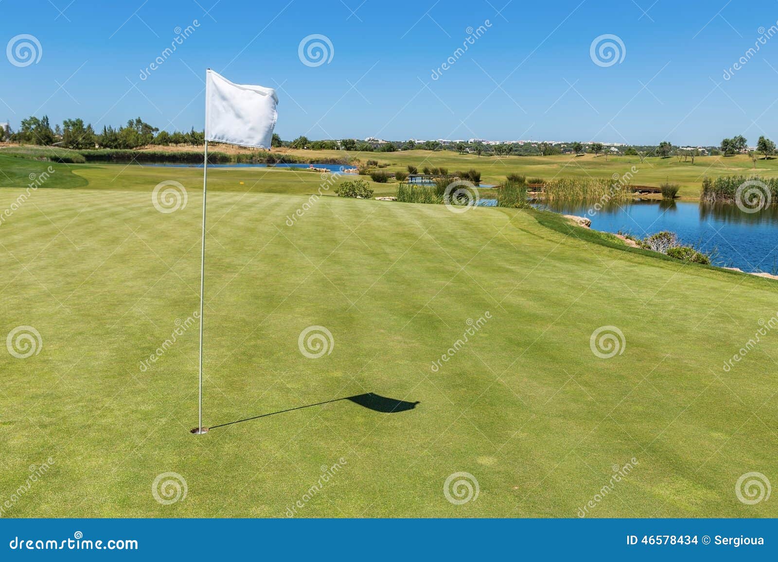 Golf Course. Flag from the Hole in the Foreground Stock Photo - Image ...