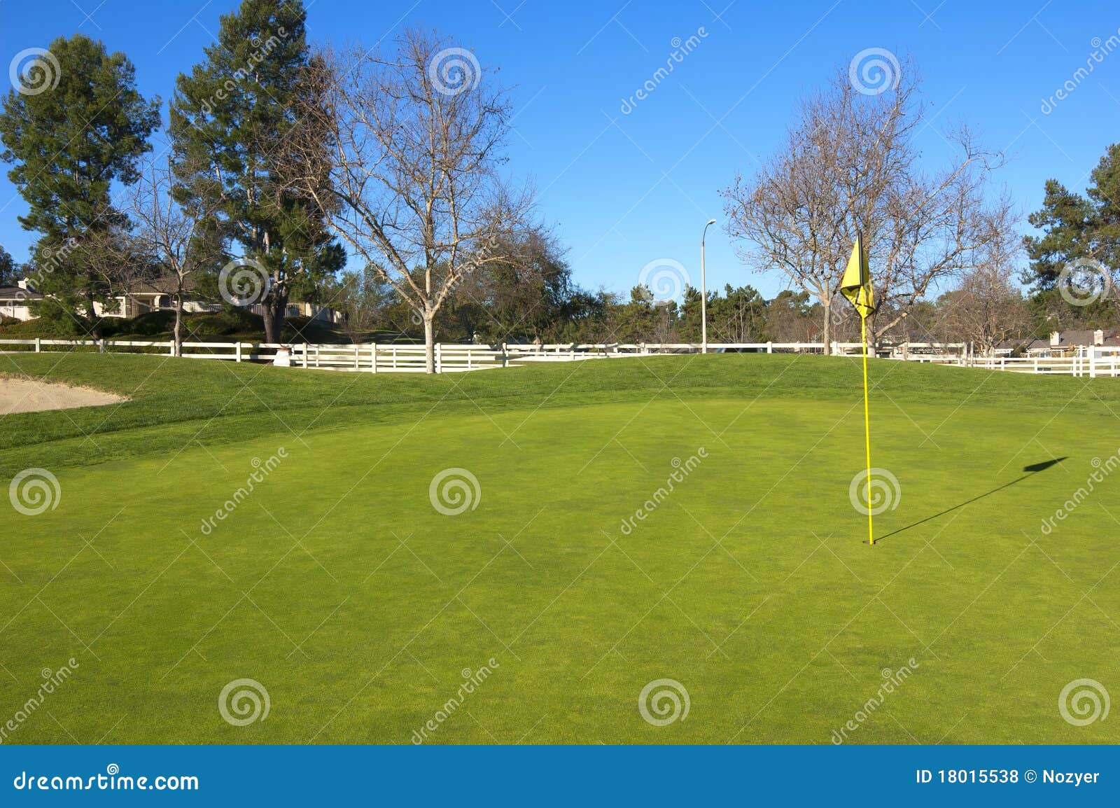 Golf Course with Green Grass, Trees and Fence Stock Photo - Image of ...