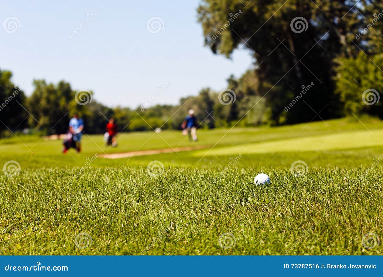 Golf course with players stock photo. Image of outdoor - 73787516