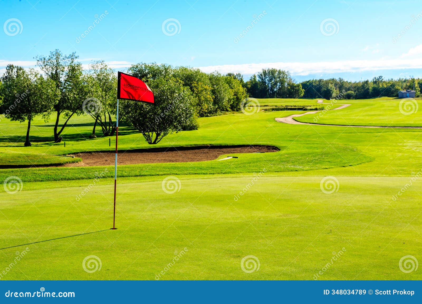 A Golf Course with a Red Flag on the Green Grass Stock Image - Image of ...