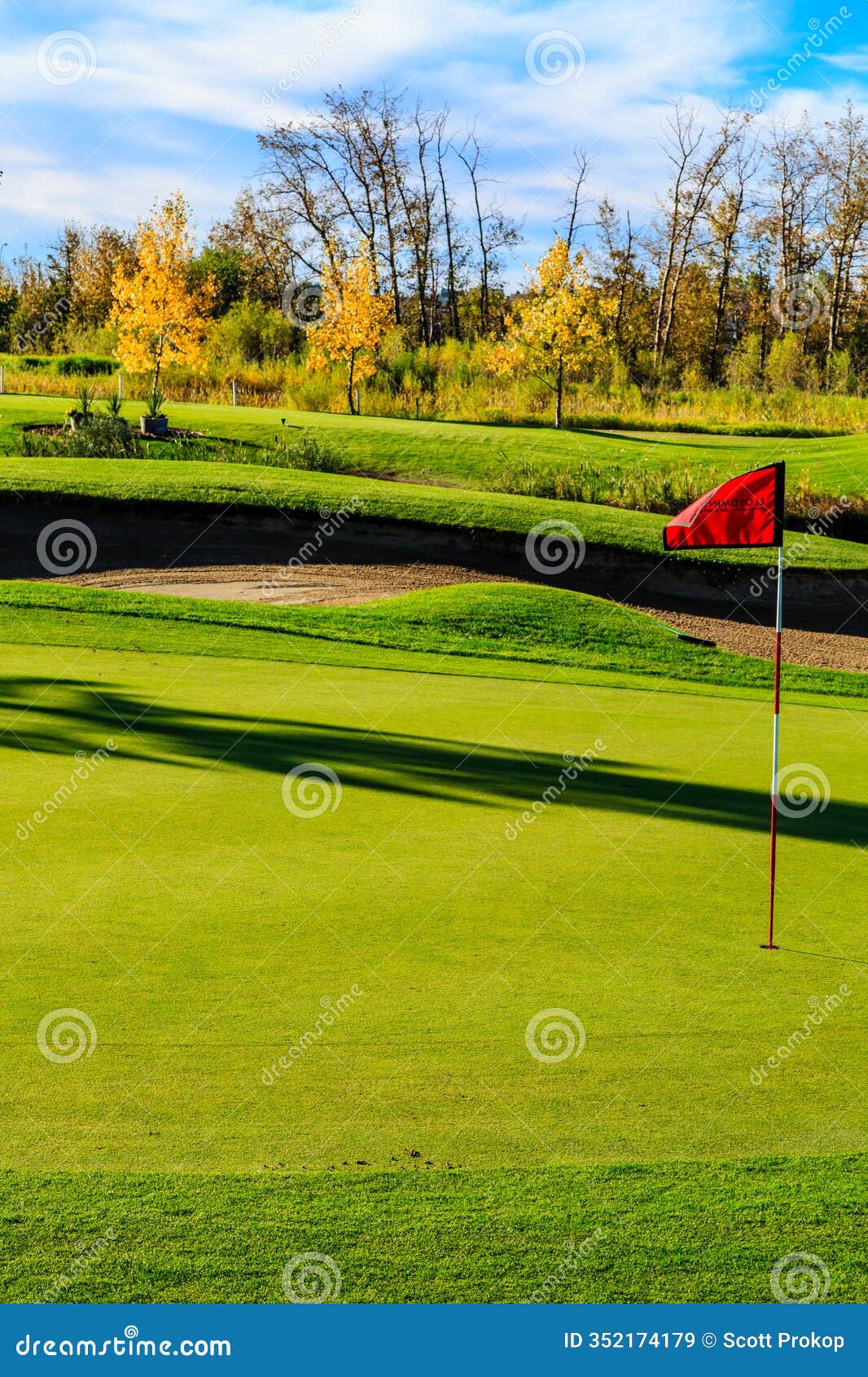 A Golf Course with a Red Flag on the Green Grass Stock Image - Image of ...