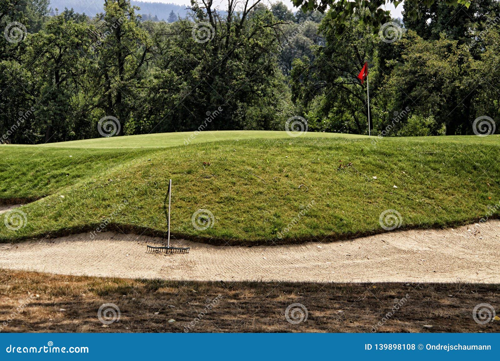 Golf Playground Grass Hill with Flag on the Hole and Rake Stock Photo ...