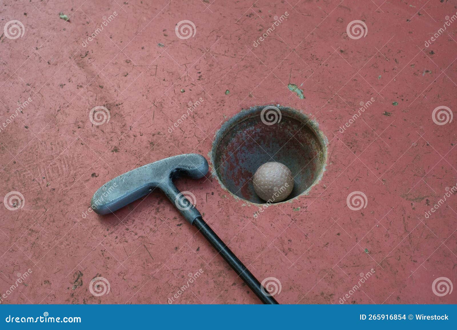 Golf Putter Next To a Hole with a Ball in it Stock Photo - Image of ...