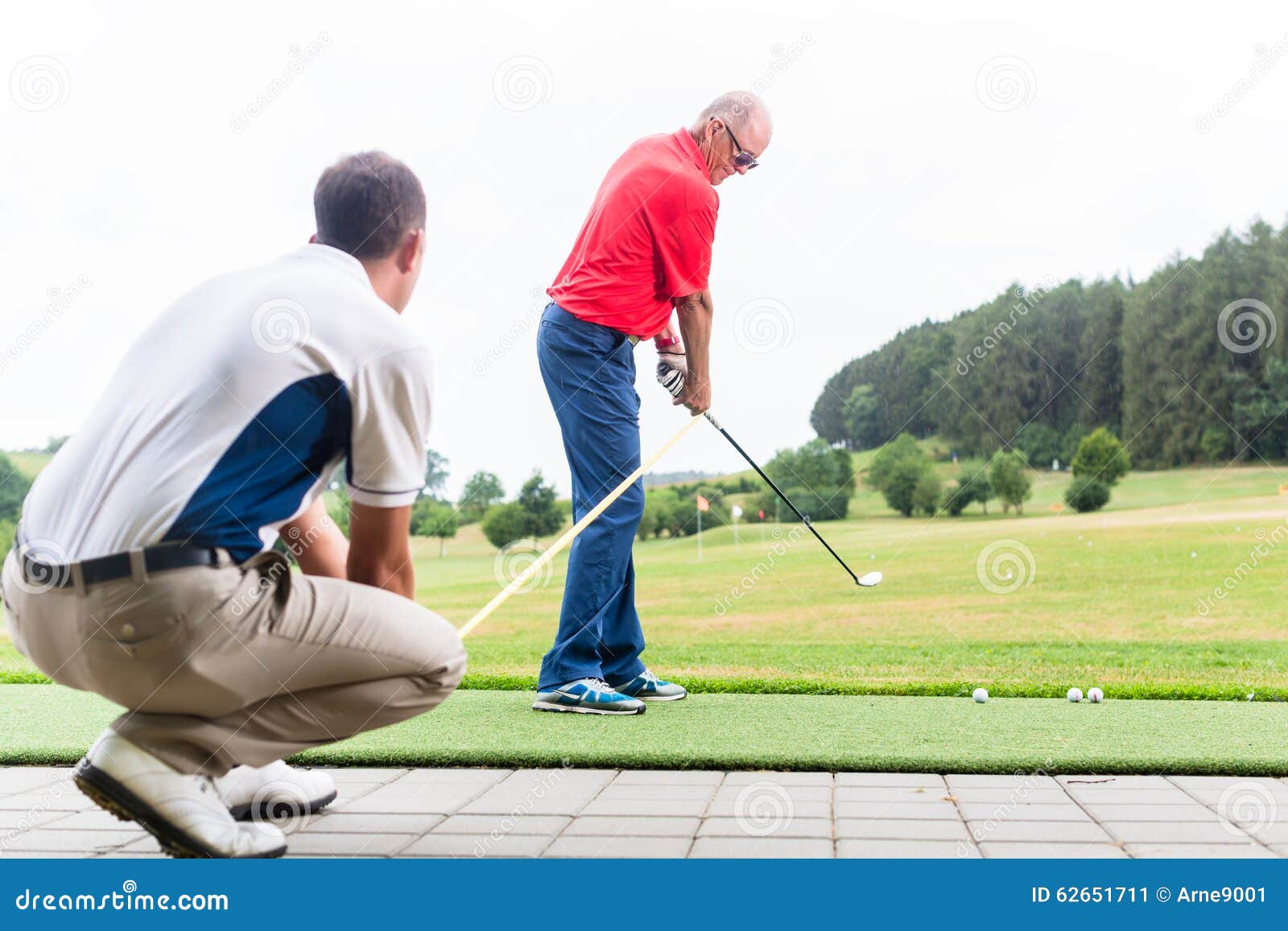 Golf Trainer Working with Golf Player on Driving Range Stock Image ...