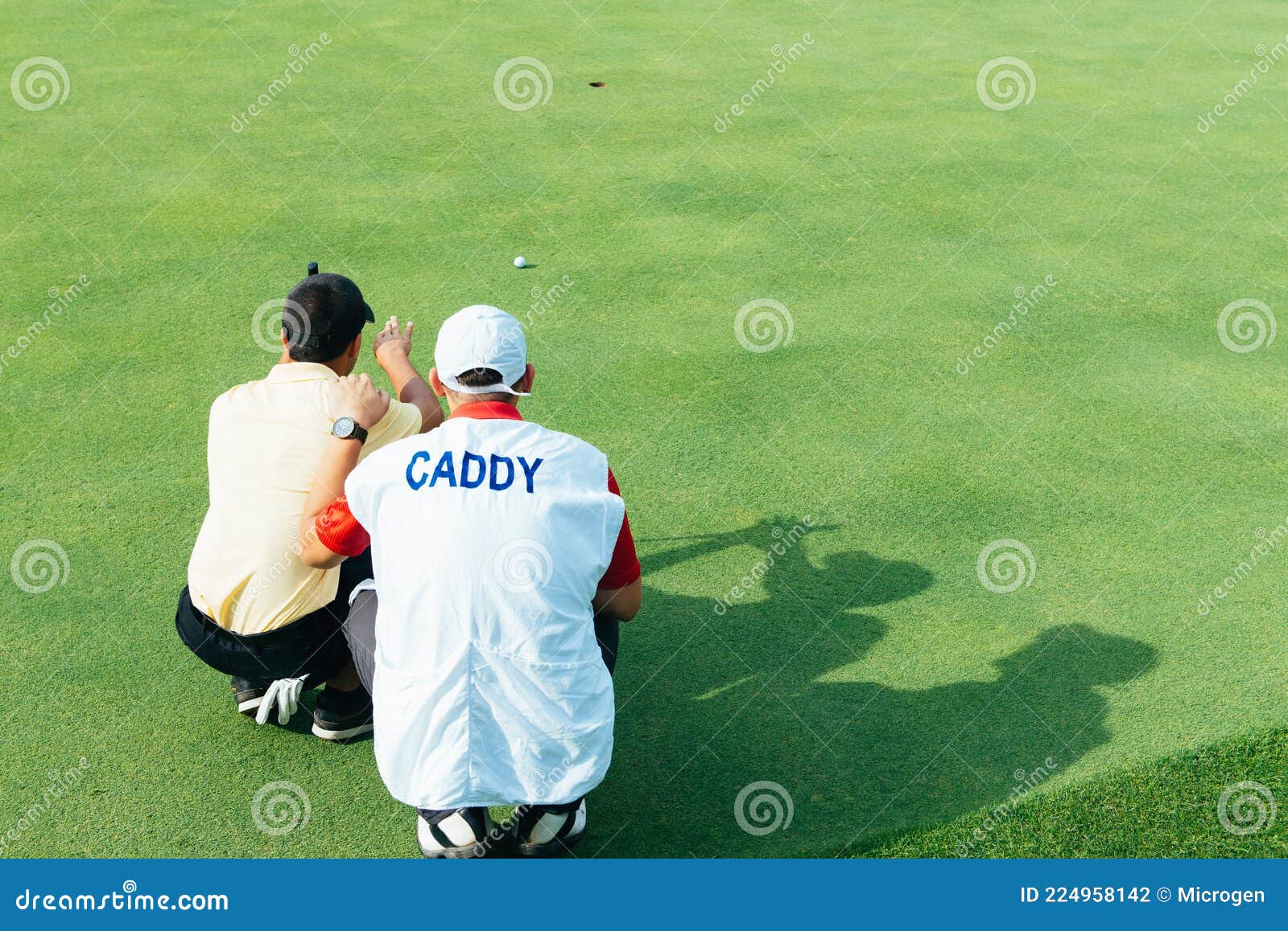 Golfer and caddy stock photo. Image of outdoors, competition - 224958142